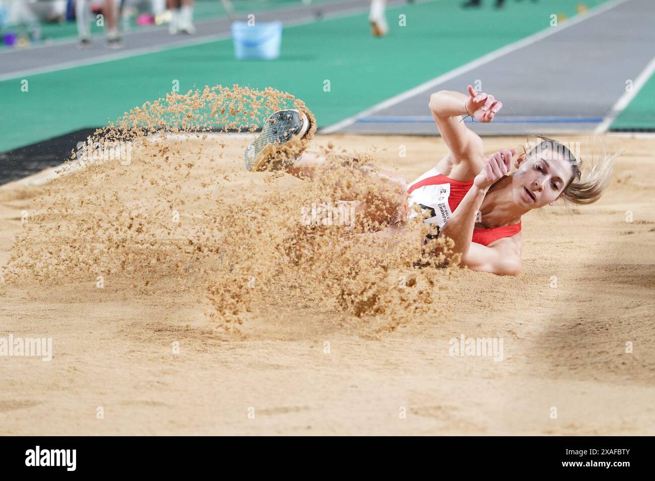 ISTANBUL, TURKIYE - FEBRUARY 10, 2024: Undefined athlete long jumping ...