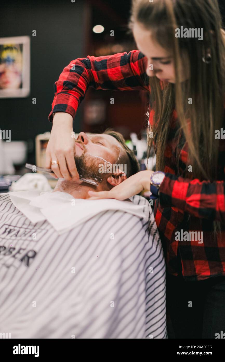 Barbershop. Barber working process with clients. Beard and hair trimming Stock Photo - Alamy