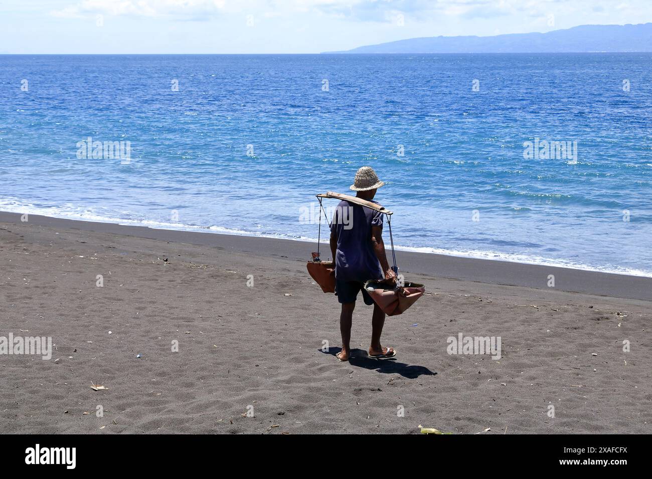 Kusamba, Bali in Indonesia - February 08 2024: Farmer collecting water ...