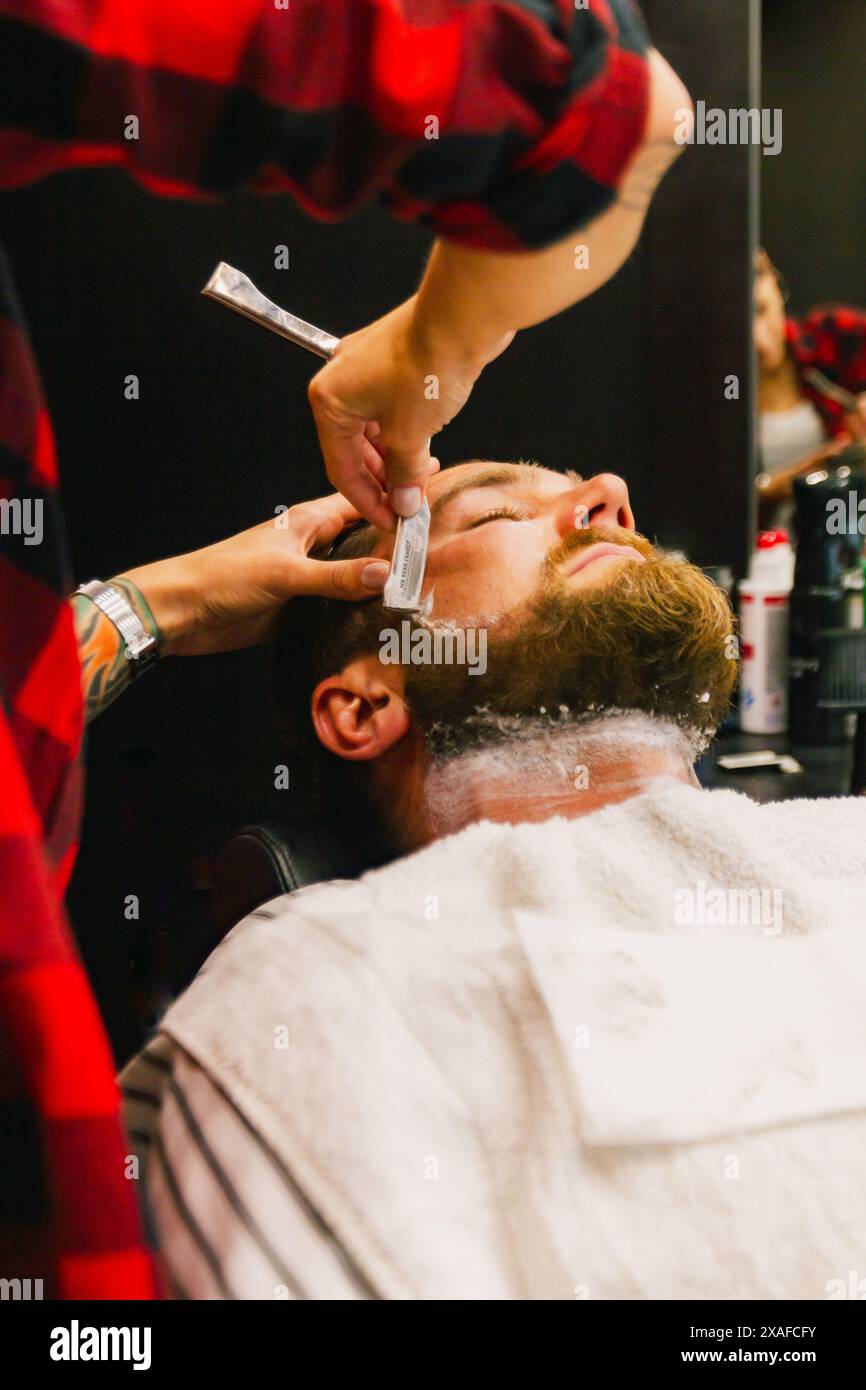 Barbershop. Barber working process with clients. Beard and hair trimming Stock Photo - Alamy