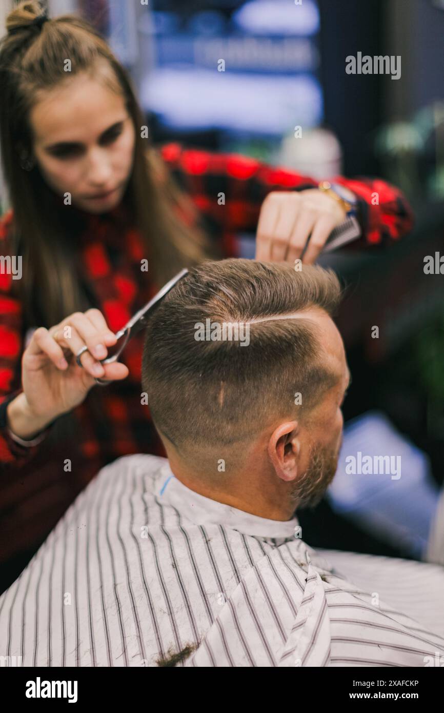 Barbershop. Barber working process with clients. Beard and hair trimming Stock Photo - Alamy