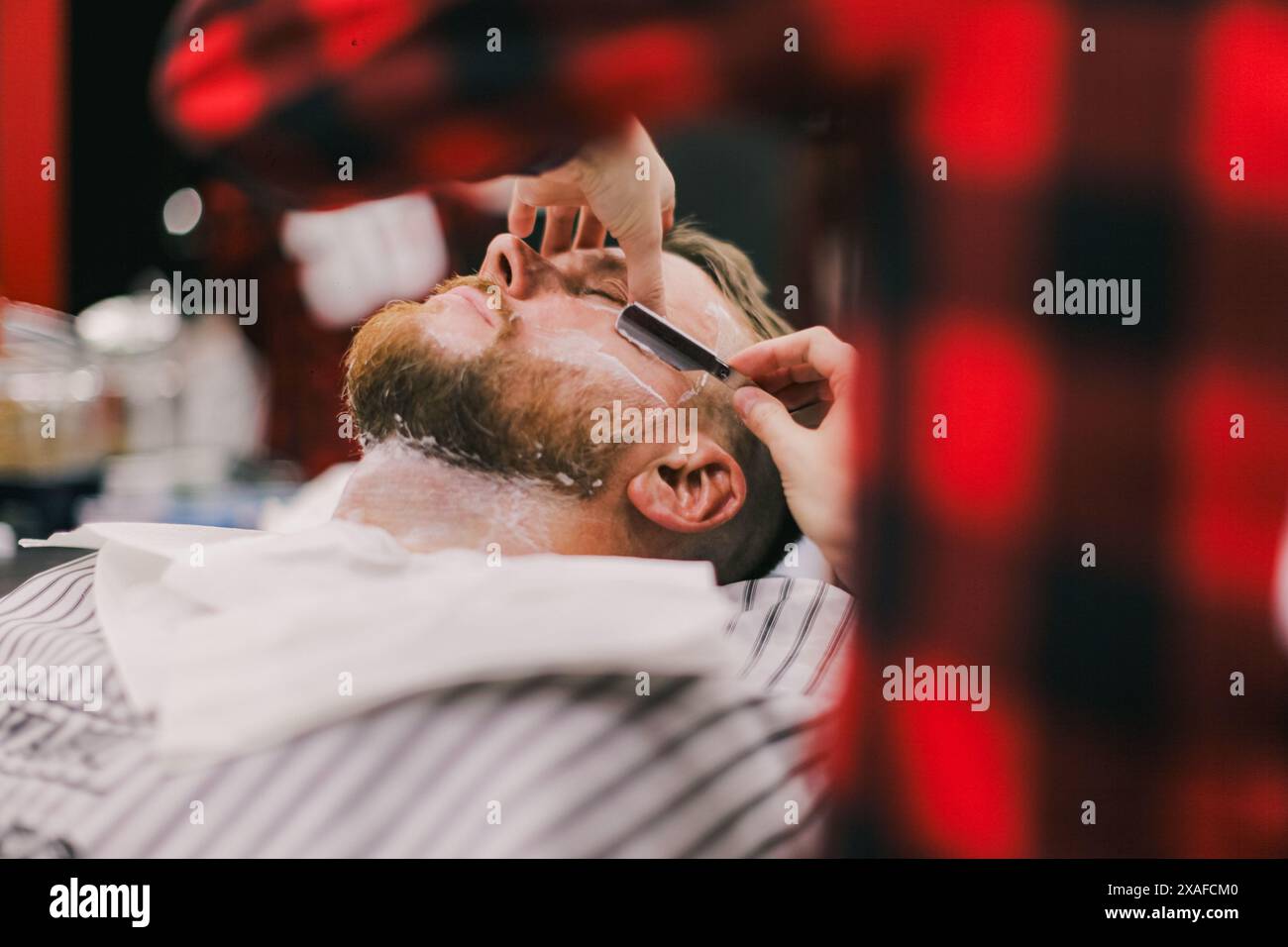 Barbershop. Barber working process with clients. Beard and hair trimming Stock Photo - Alamy