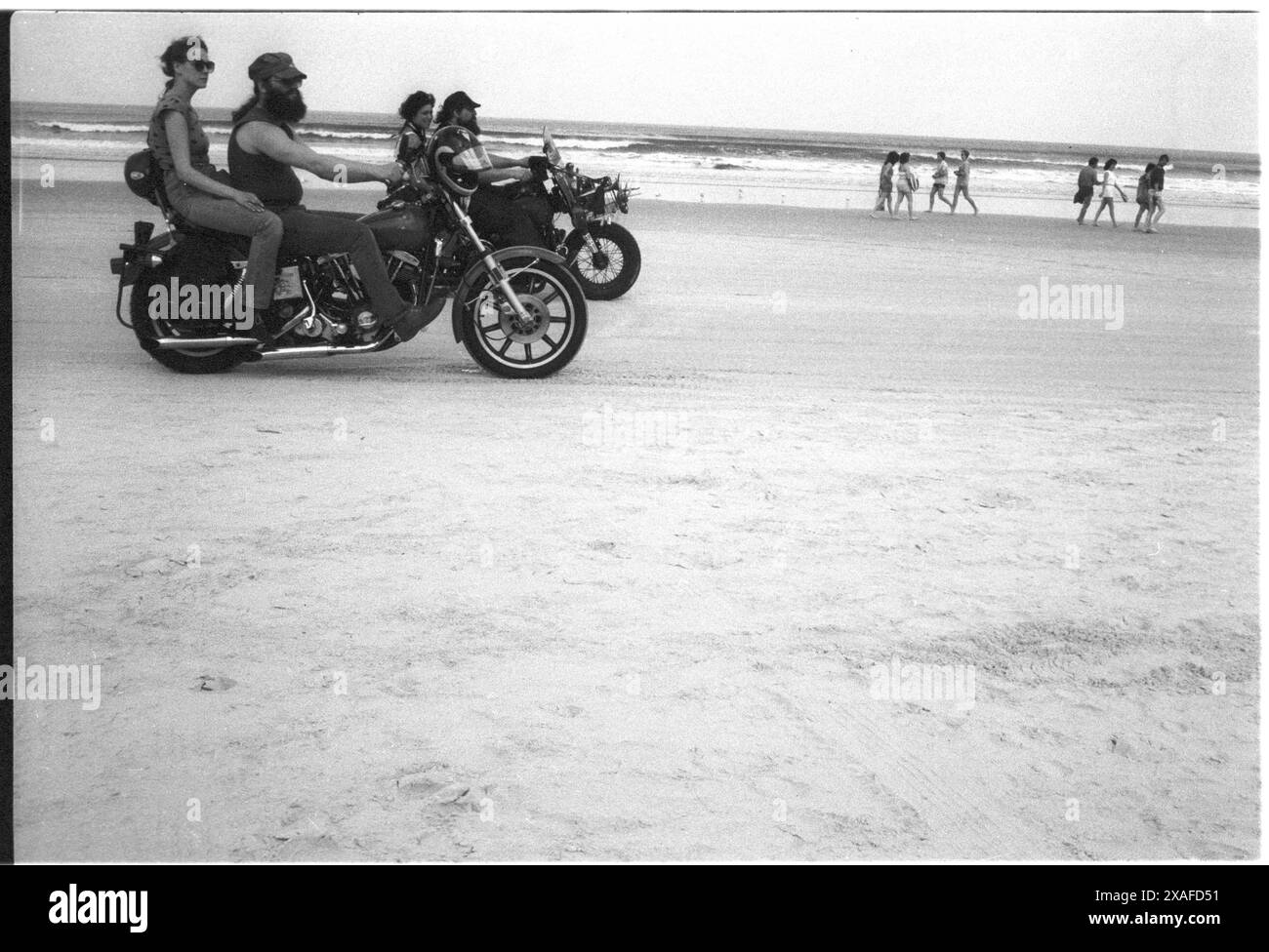 motorcycles parade on the beach during Daytona Bike Week in March of ...