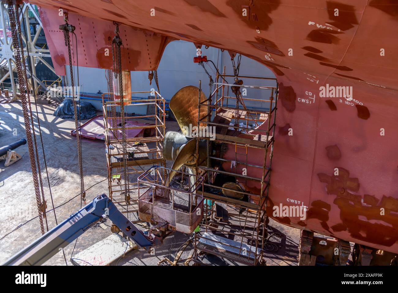 Cargo vessel in dry dock on ship repairing yard. Variable pitch ...