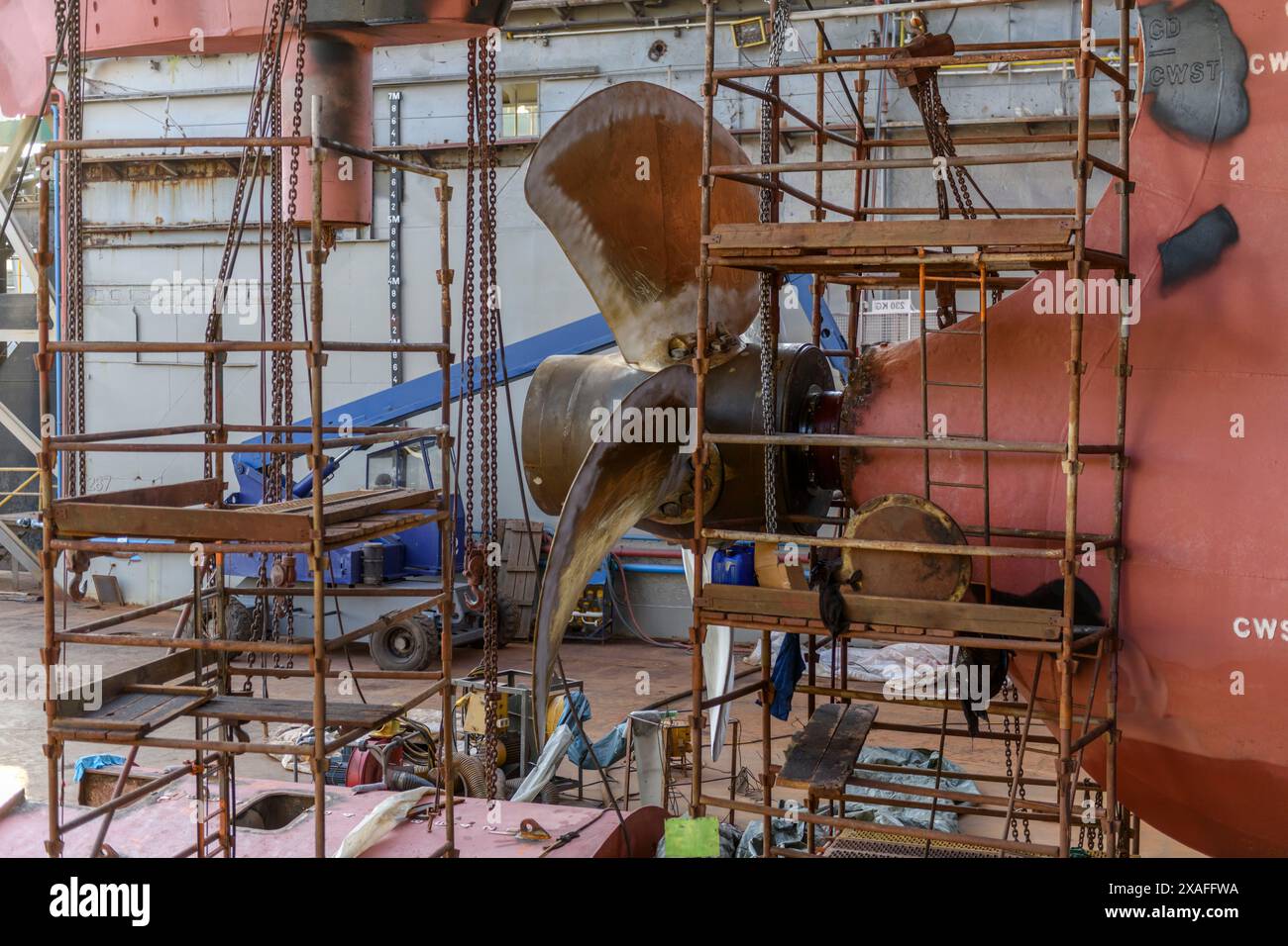 Cargo vessel in dry dock on ship repairing yard. Variable pitch ...