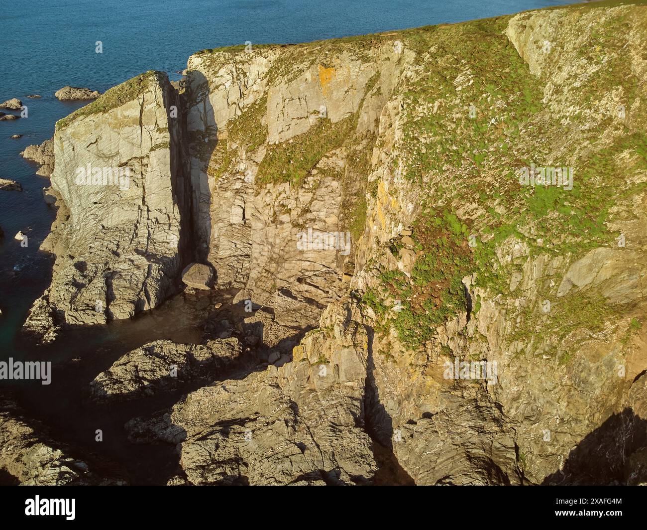 An aerial view of rugged cliffs on the south side of Burgh Island ...