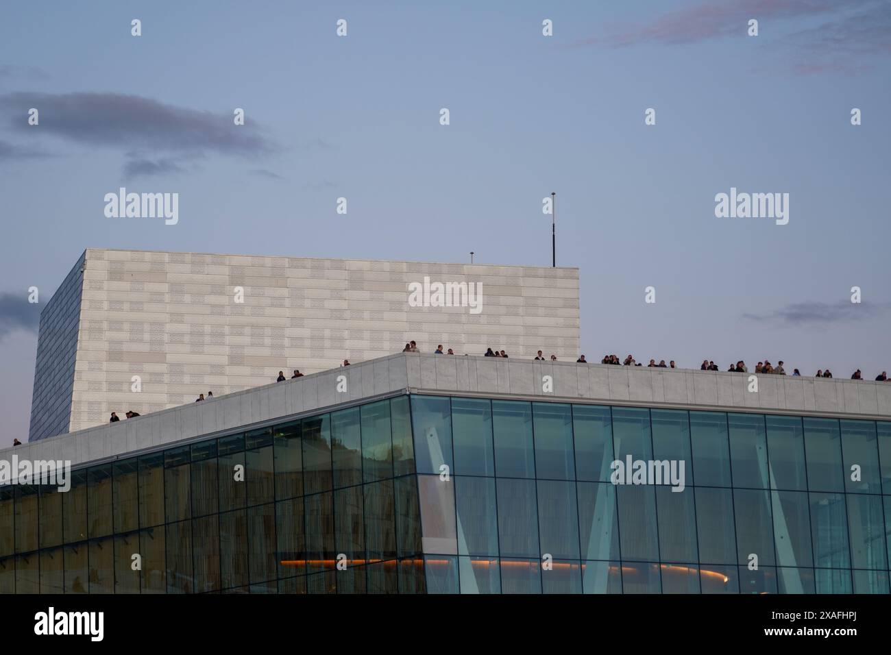 People visit the Oslo Opera House, admire the architecture and enjoy ...