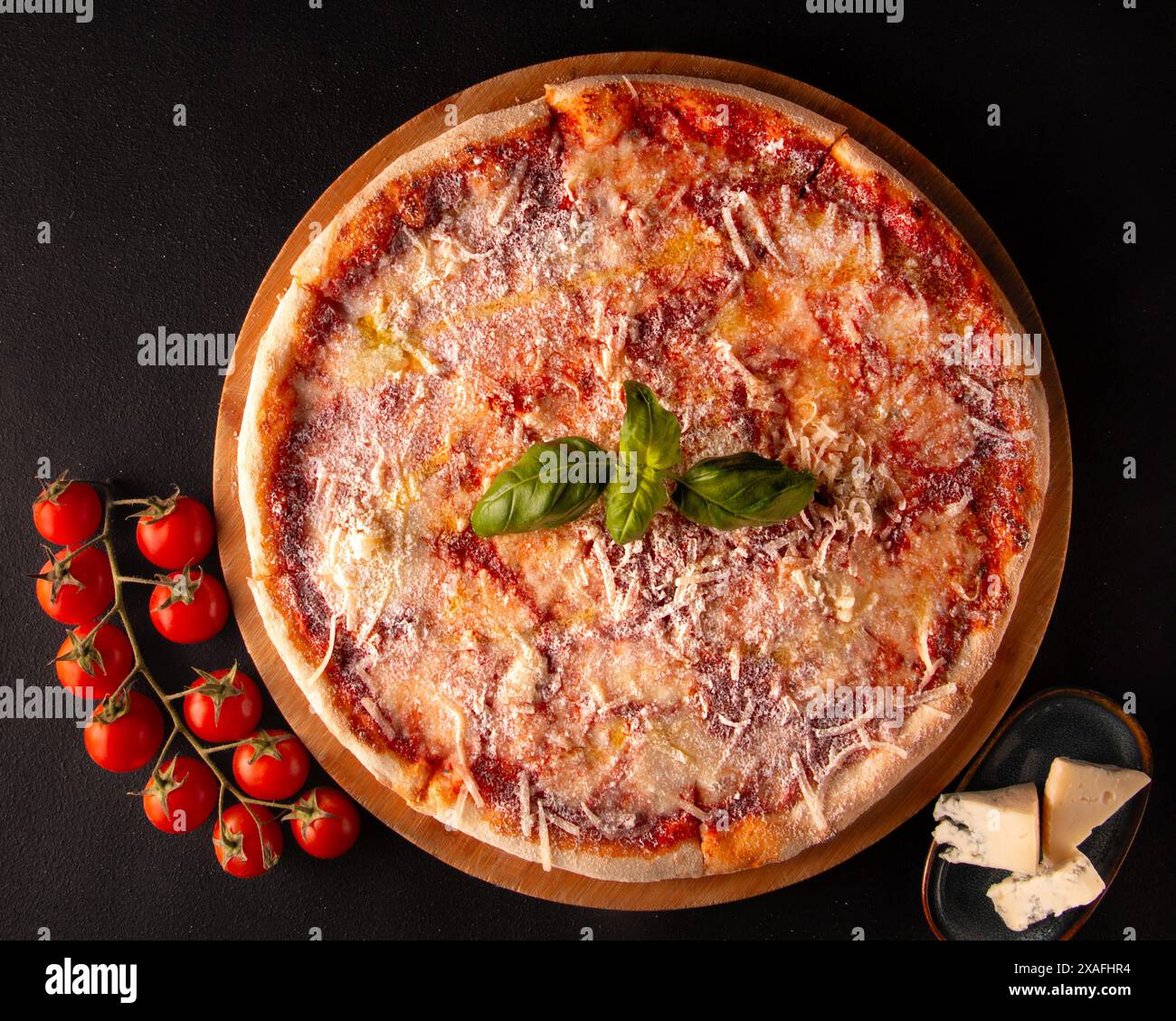 Amazing italian pizza quattro formaggi on dark background, top view Stock Photo - Alamy