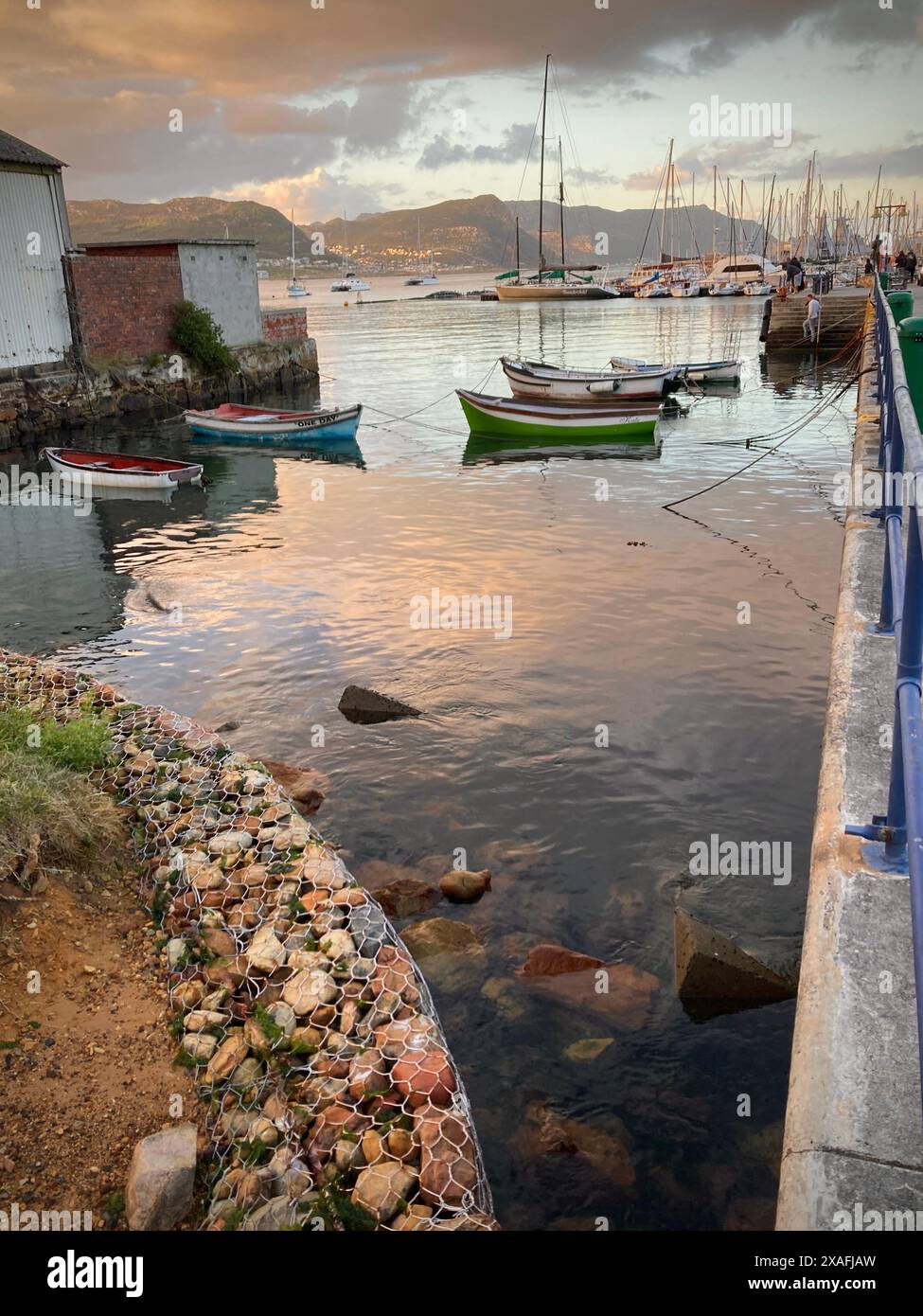 Small boats moored along side the Simon's Town jetty in early evening ...