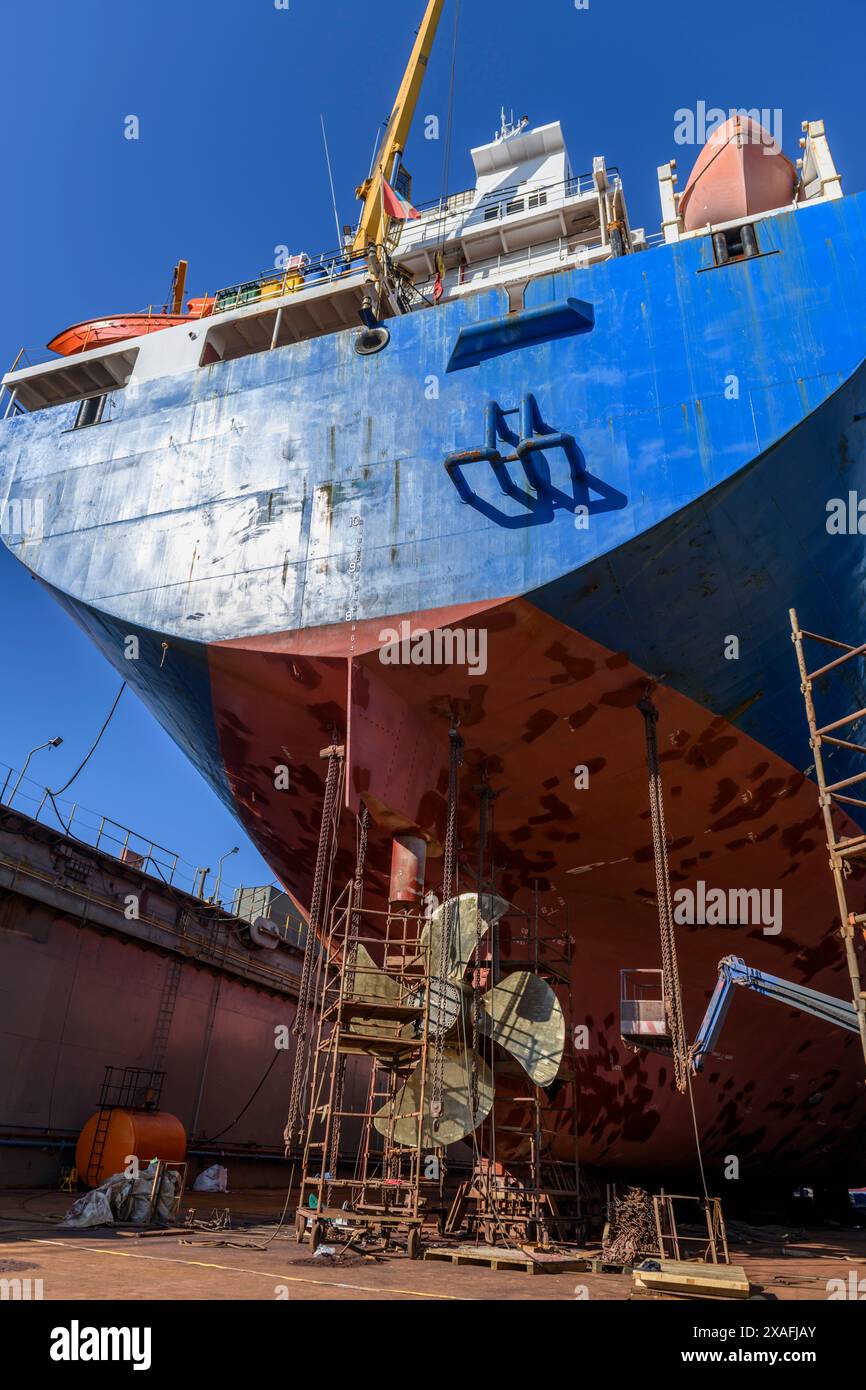 Cargo vessel in dry dock on ship repairing yard. Variable pitch ...