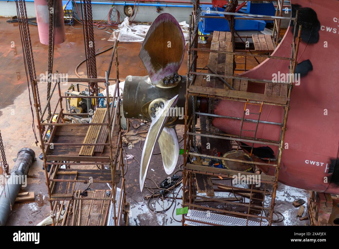 Cargo vessel in dry dock on ship repairing yard. Variable pitch ...