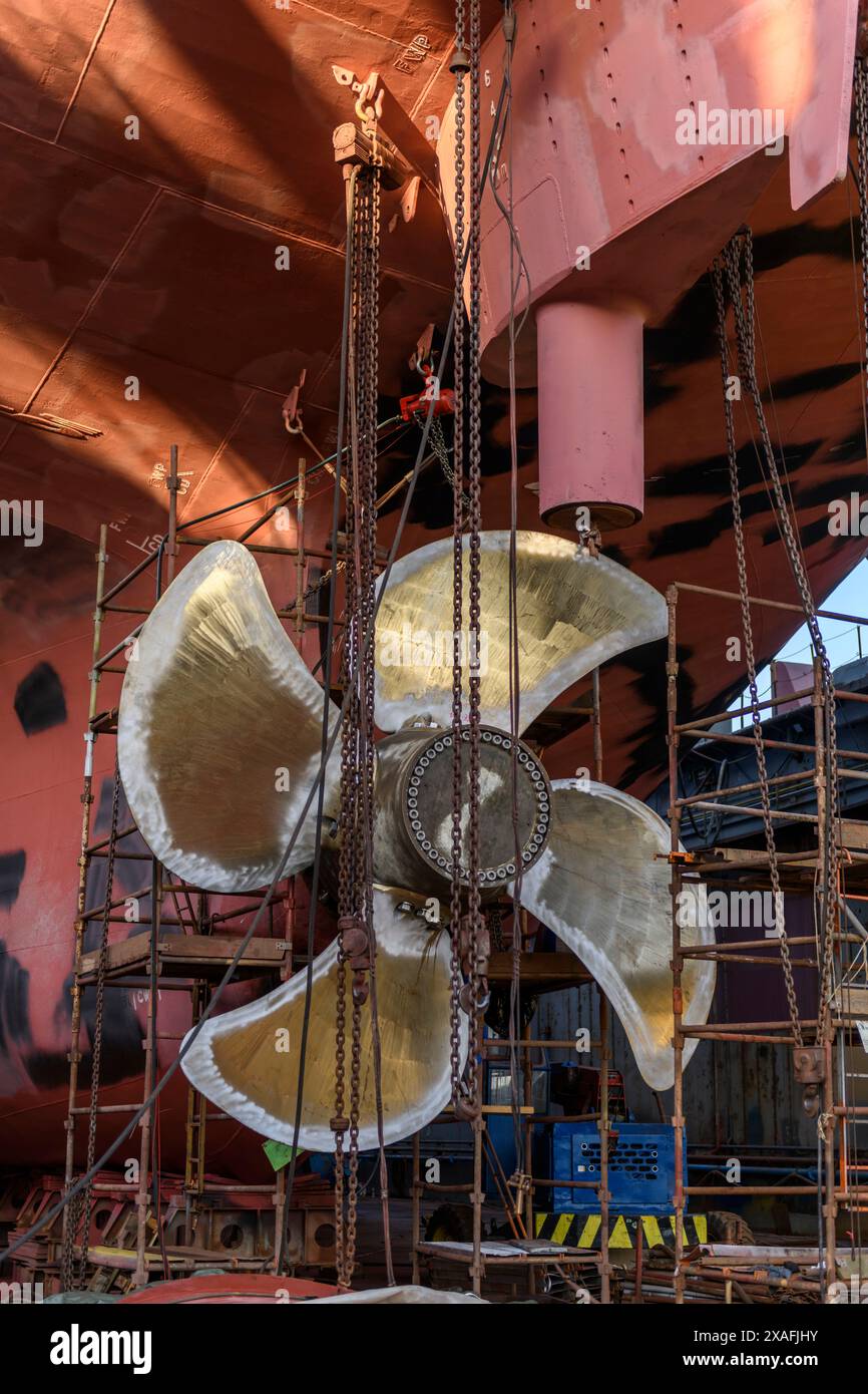 Cargo vessel in dry dock on ship repairing yard. Variable pitch ...