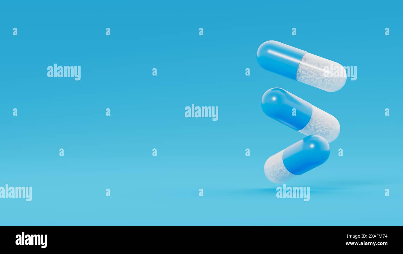 Three blue transparent capsules, pills with white granules inside float ...