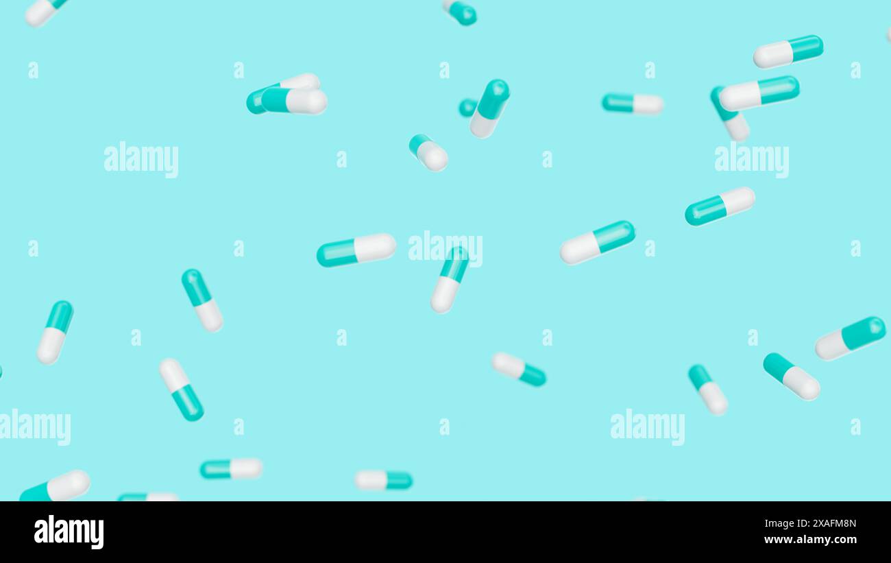 Turquoise white capsules fall against blue backdrop. Drugs, pills ...
