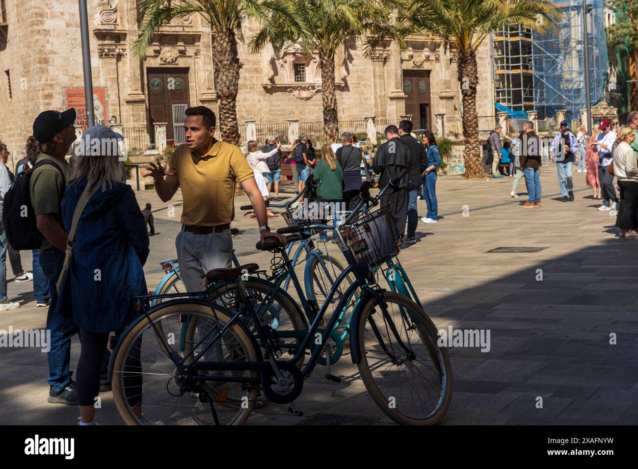 Valencia, Spain - April 20, 2024. A young male guide tells tourists the ...