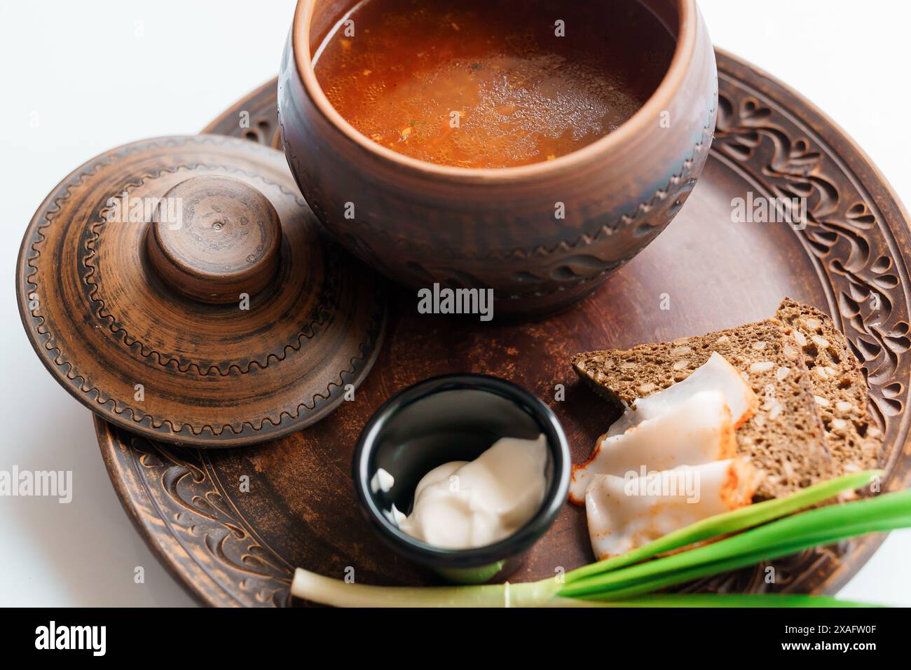 Red borscht with beets in a pan with lard and green onions Stock Photo ...