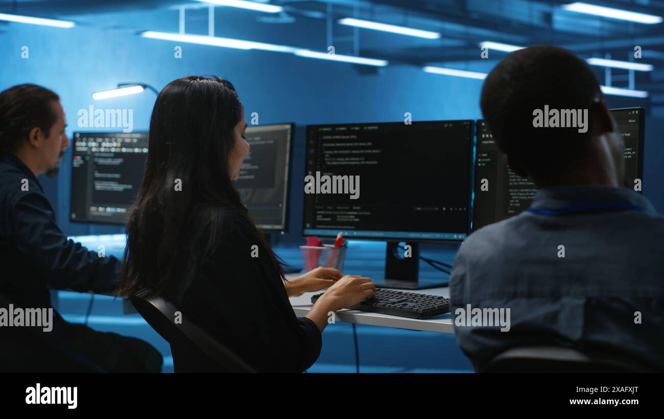 Multiethnic Team Of Engineers Working In High Tech Server Hub Using Pcs To Analyze Data