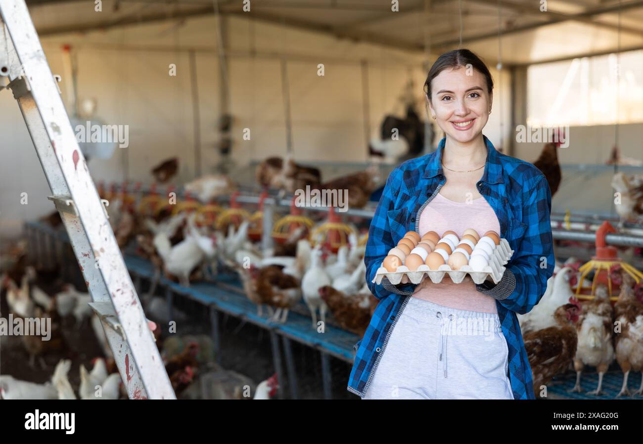 Successful female poultry farm owner holding carton tray of eggs Stock ...
