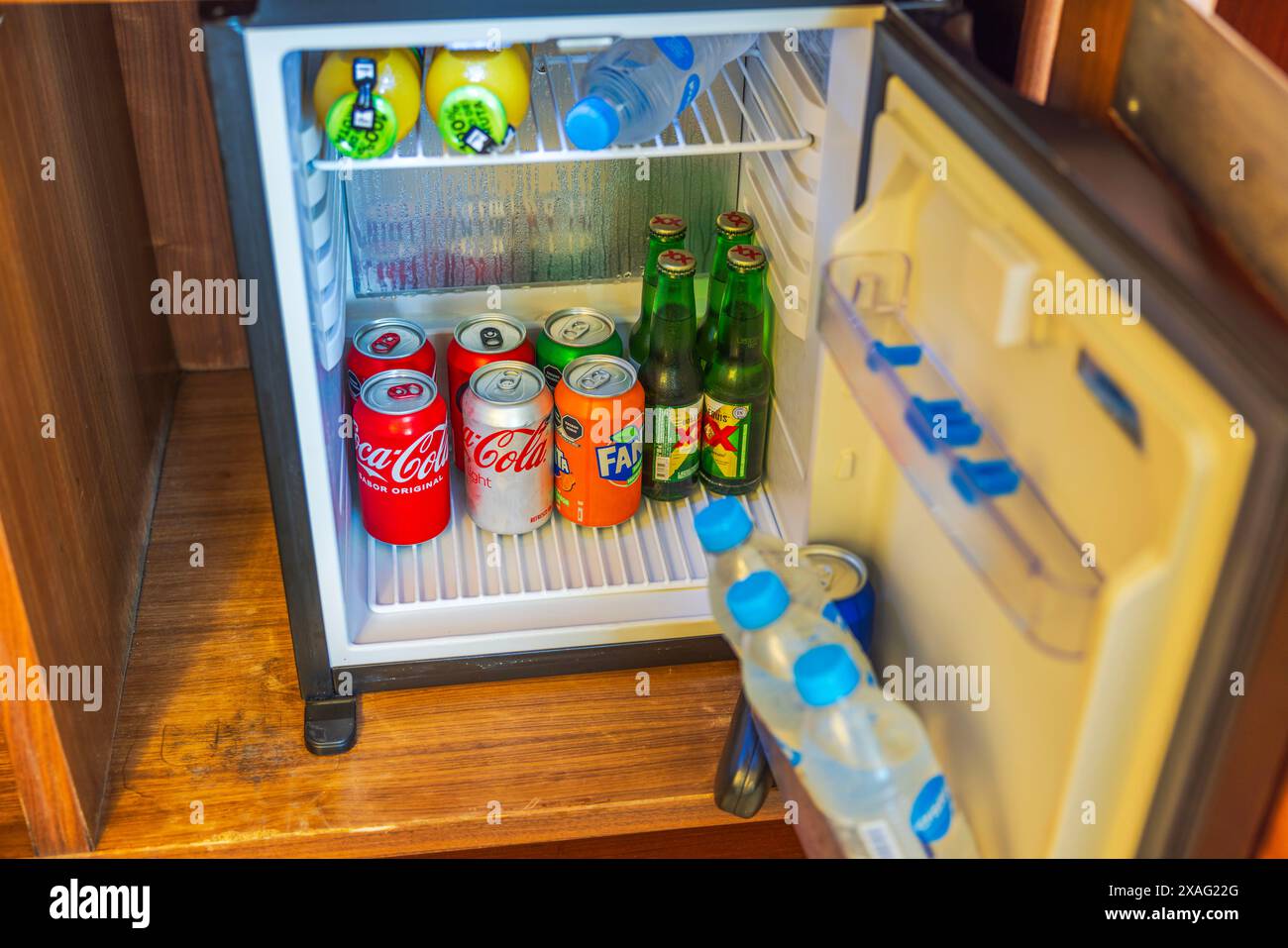 Close-up view of an open mini-bar with various refreshments in a hotel ...