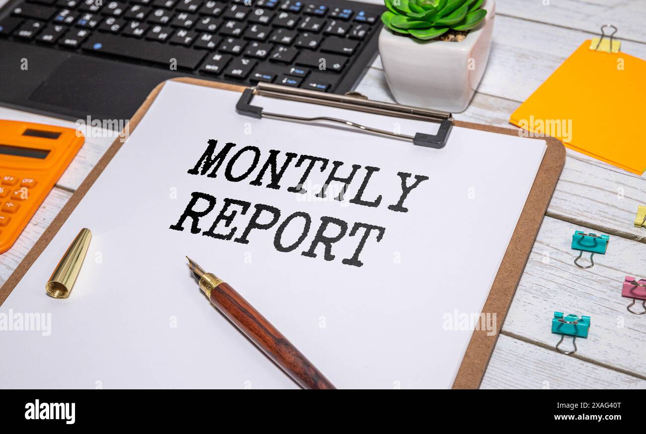MONTHLY REPORT - text on a notepad with wrinkled paper and paper ...