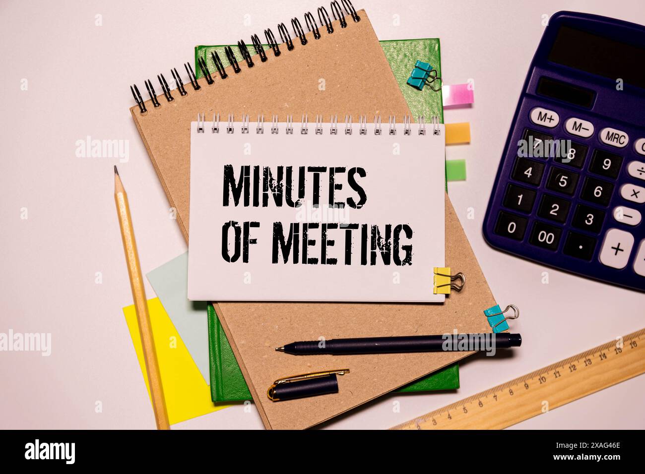 Office leather desk table with white notepad with text MINUTES OF THE ...