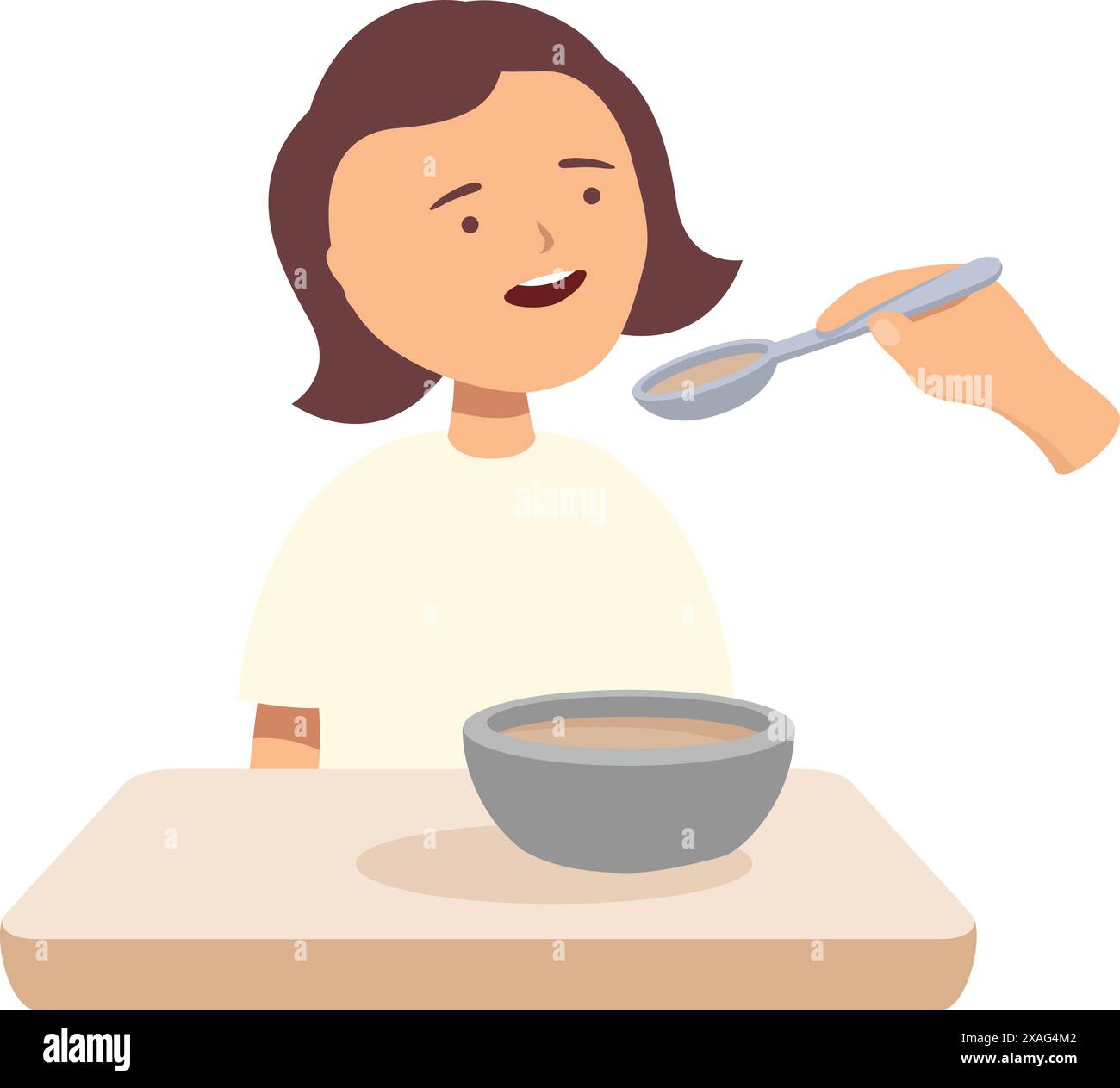 Young patient is being fed a spoonful of food by a nurse while sitting ...