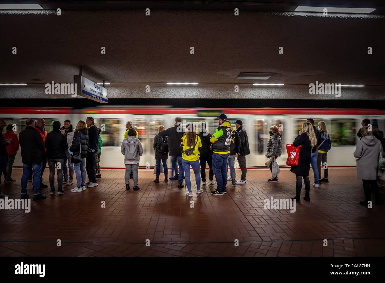 People waiting for a tram at Dortmund Stadtbahn station, illustrating ...