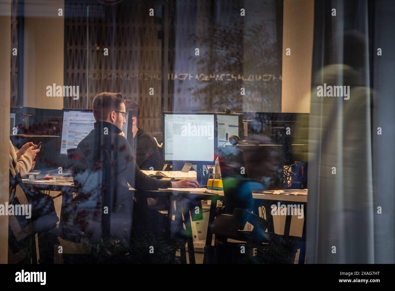 Picture of a young man working on a computer in Aachen, germany, in an ...