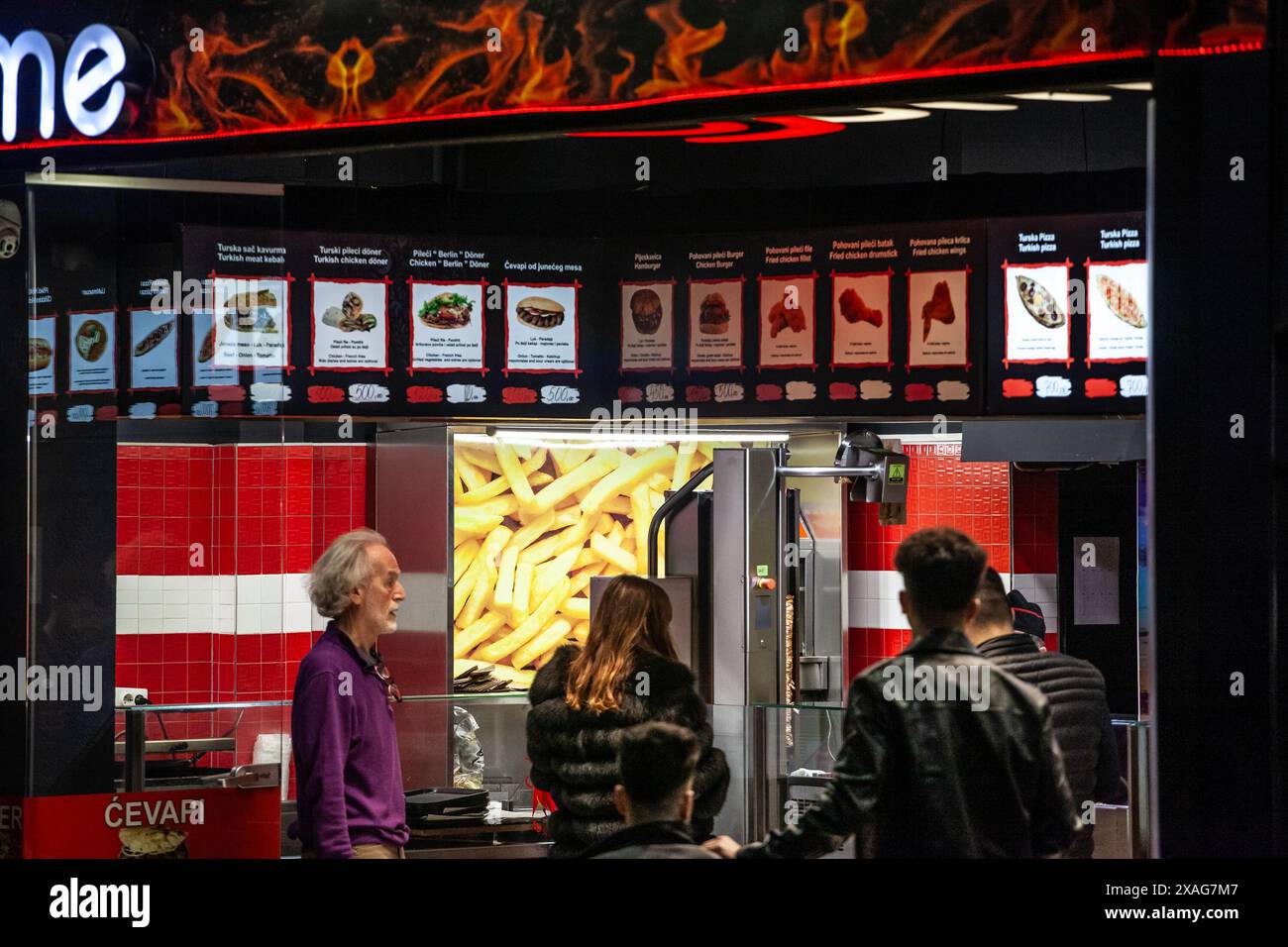 Picture of a turkish fast food, a kebab, with clients waiting to order ...