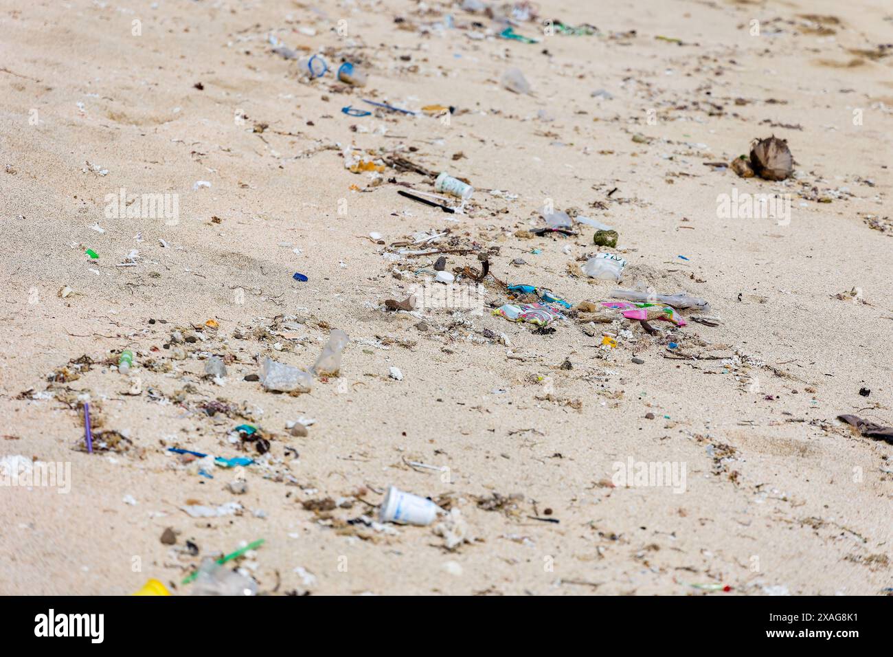 Plastic bags and other trash washed up on the beach of Tampah near Kuta ...