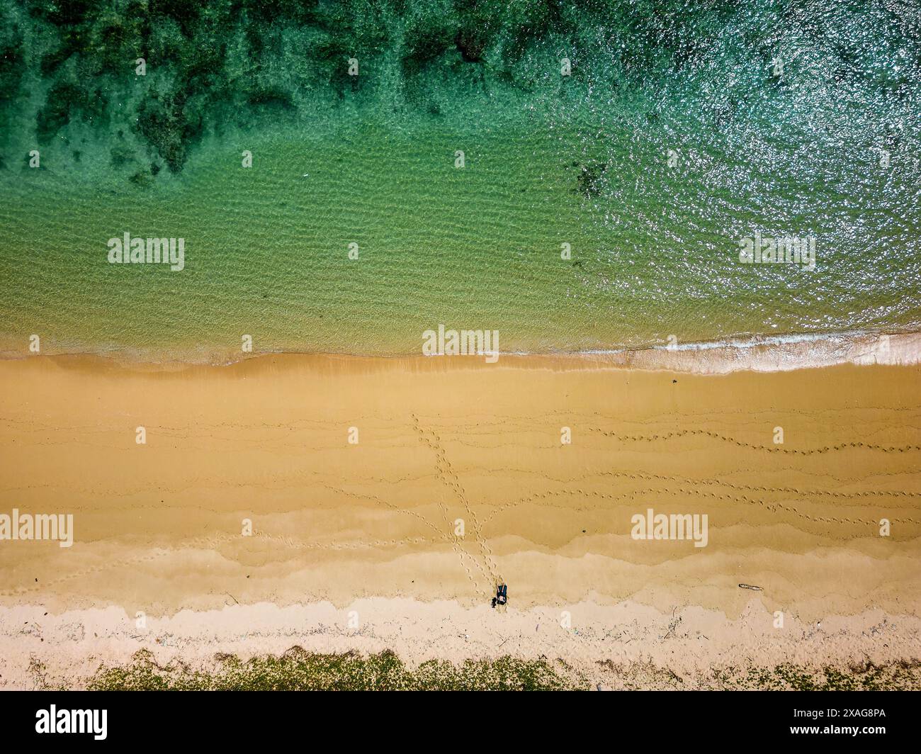 Top down aerial view of a deserted tropical beach and shallow, warm ...