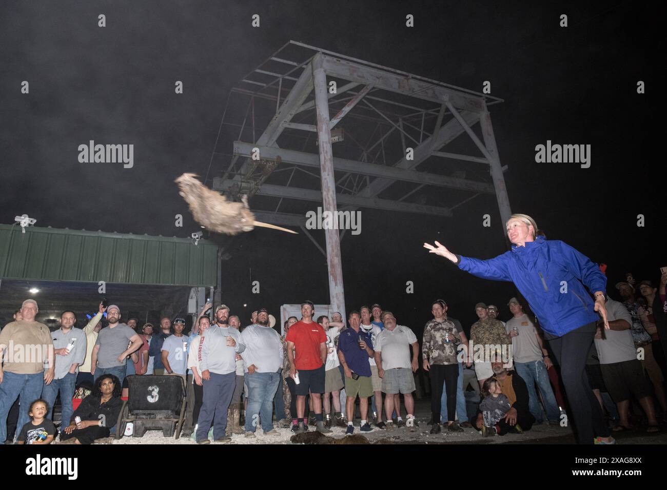 Participant hurls a dead nutria in the "nutria toss" contest at the ...