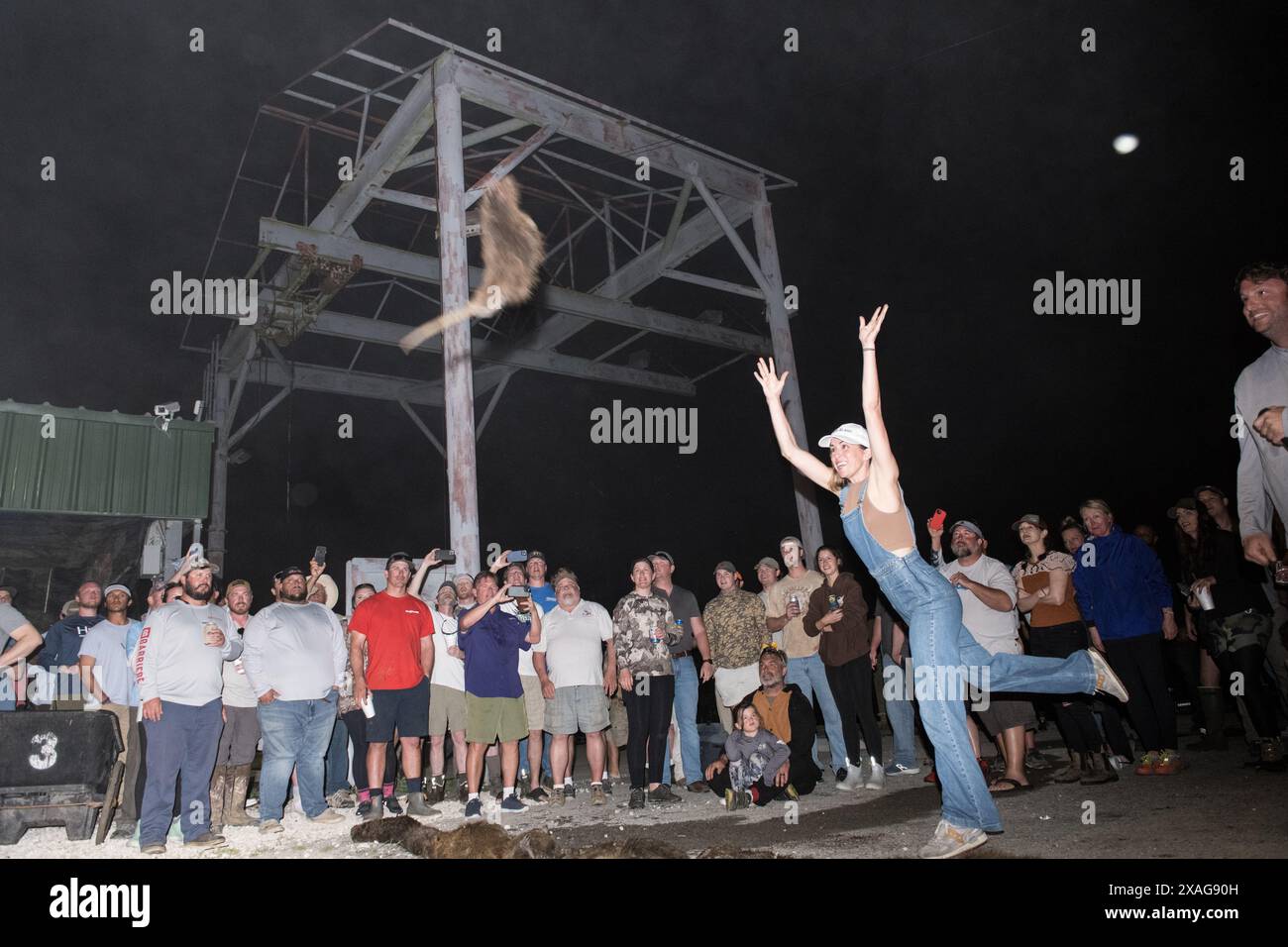 Participant hurls a dead nutria in the "nutria toss" contest at the ...