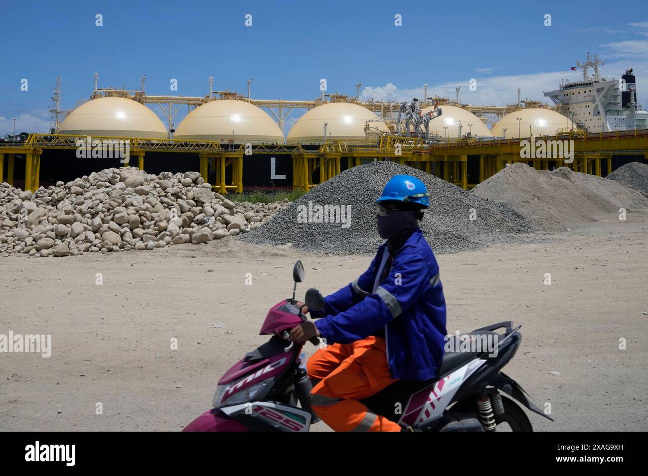 A man passes by the Ilijan power plant at the coastal village of Ilijan ...