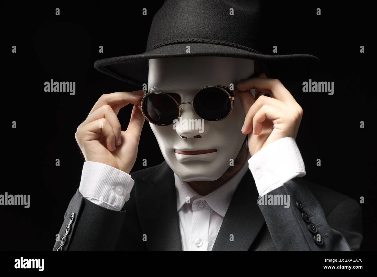 Theatrical performance. Man with plastic mask and sunglasses on black ...