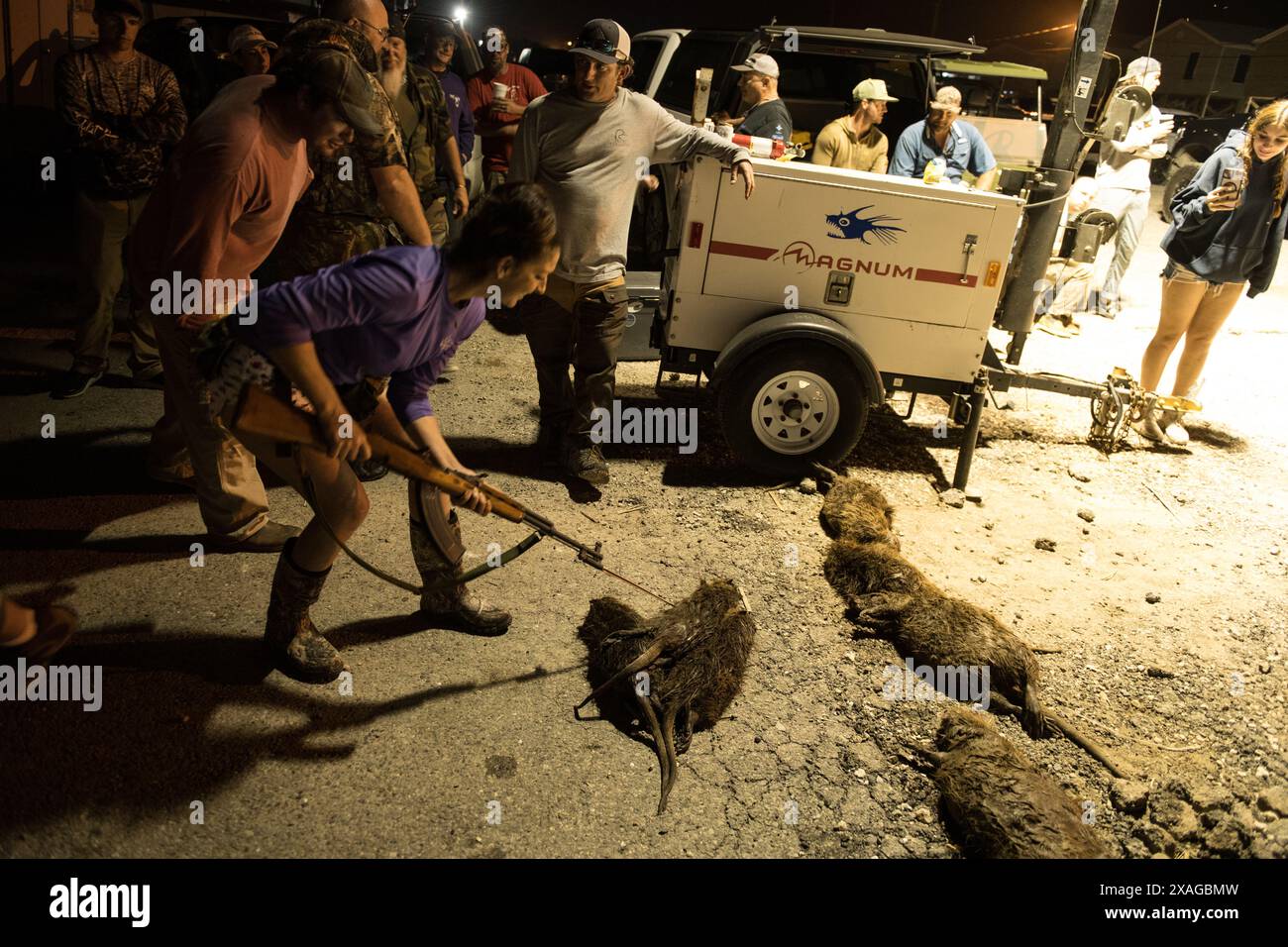 Armed nutria hunters proudly display their rifles at the annual Nutria ...