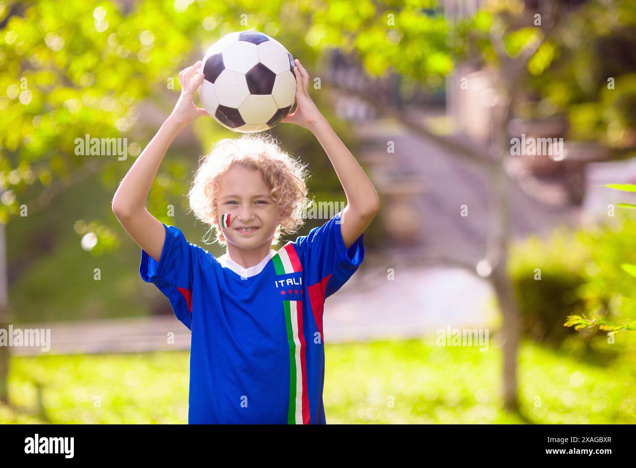 Italy football fan. Italian kids play soccer on outdoor field. Cheering ...