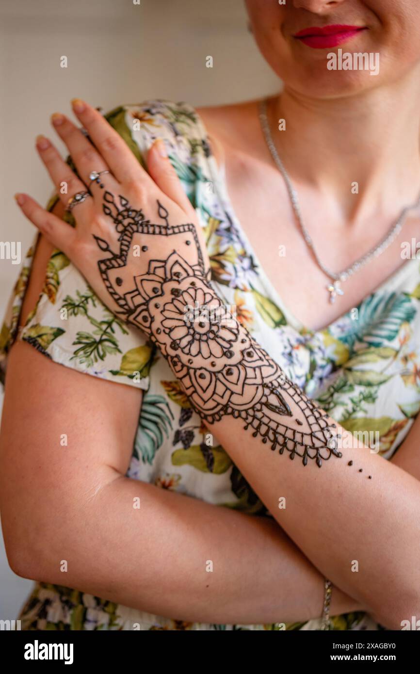 This image shows a close-up of a womans forearm adorned with a detailed ...