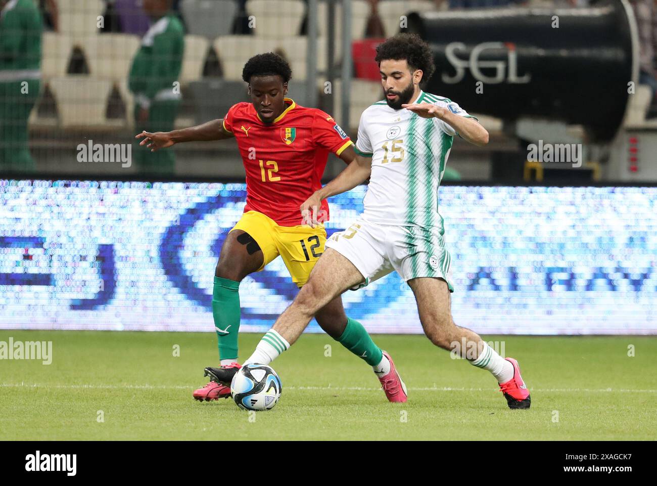 Algiers. 7th June, 2024. Algeria's Rayan Ait Nouri (R) vies with Guinea ...