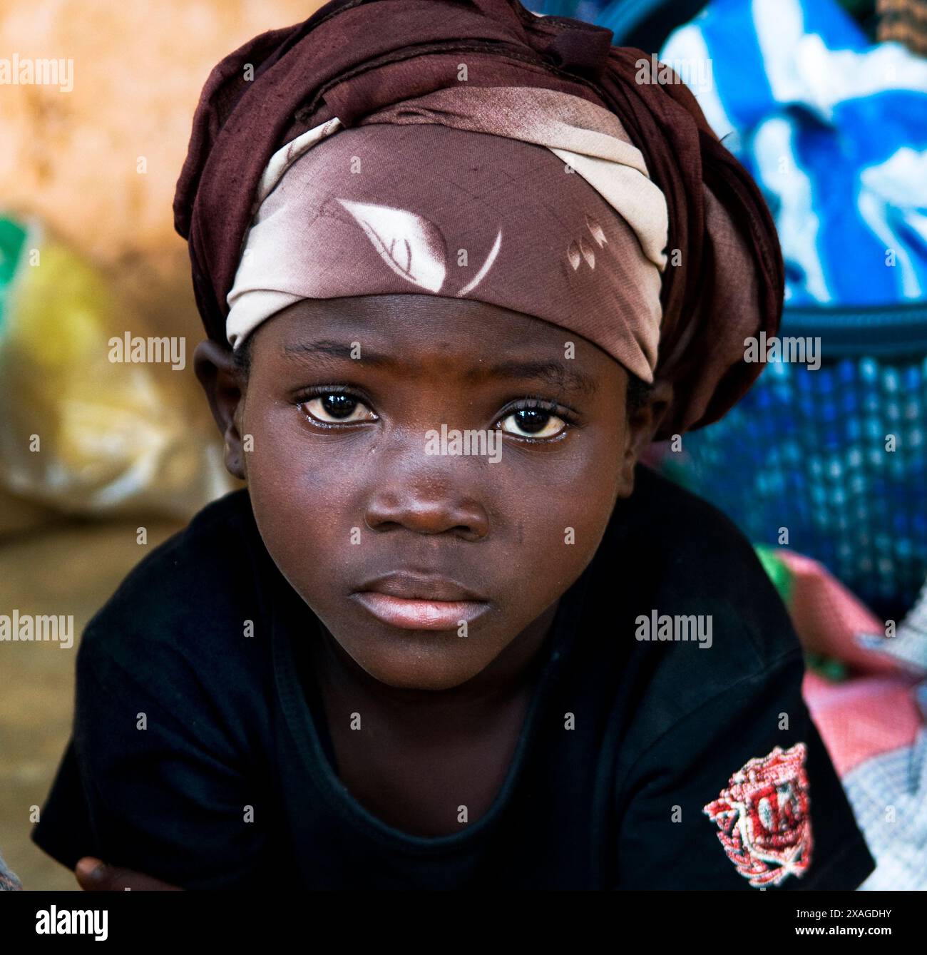 Portrait of a shy Beninese girl taken in her village in northern Benin ...