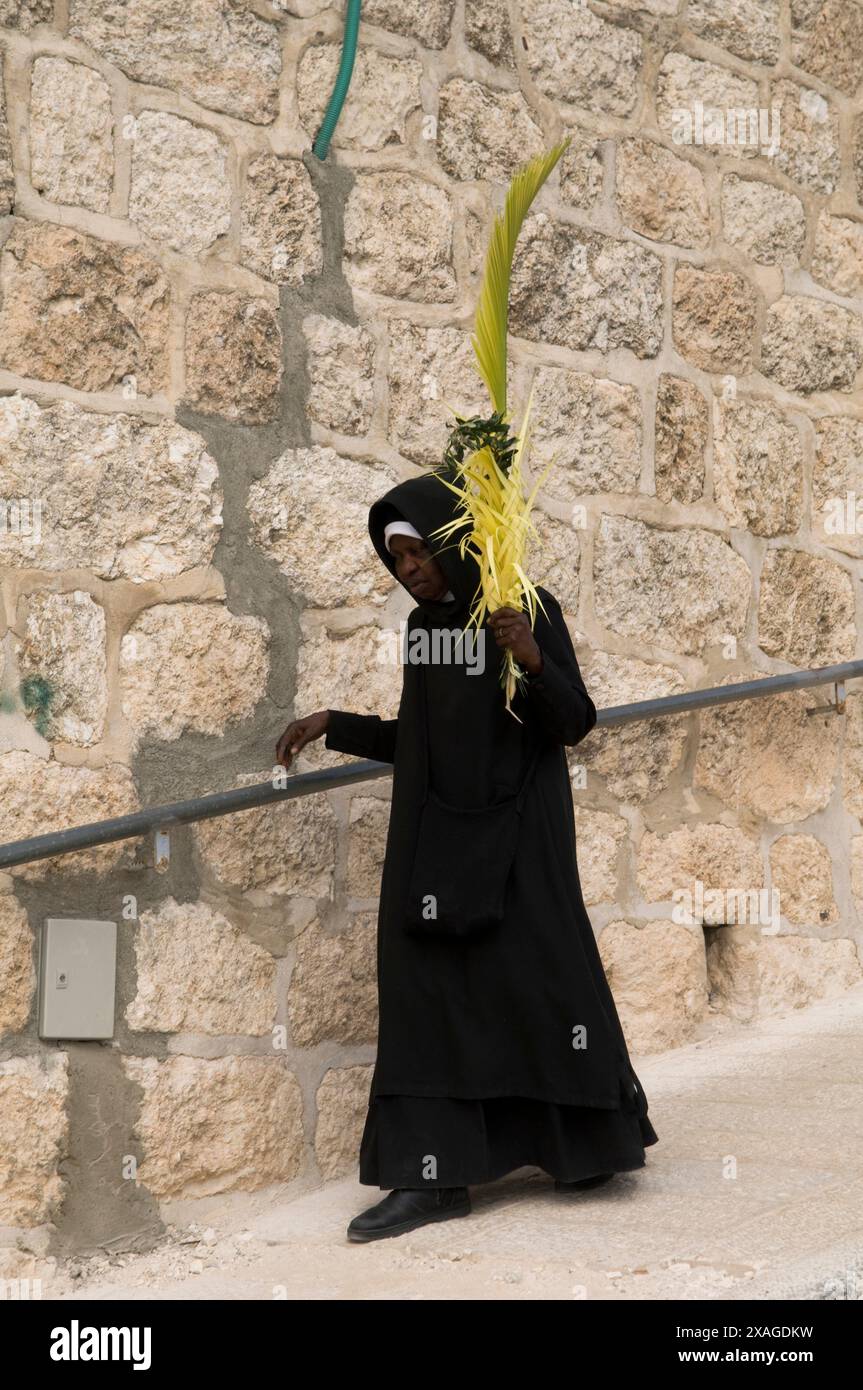 A Catholic nun holding an olive branch during the Palm Sunday ...
