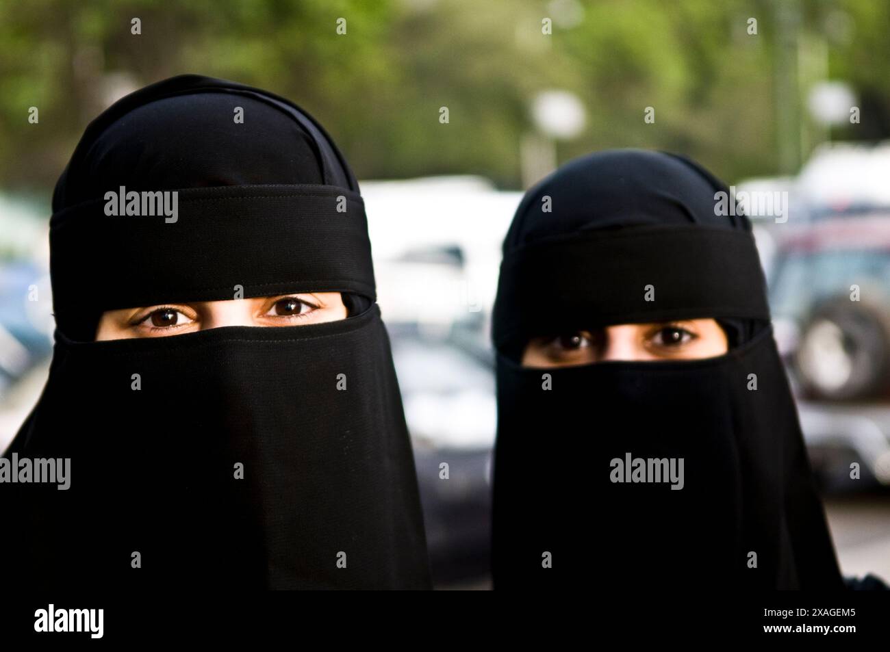 Smiling beneath the veil. Young Arab girls wearing burqa Stock Photo ...