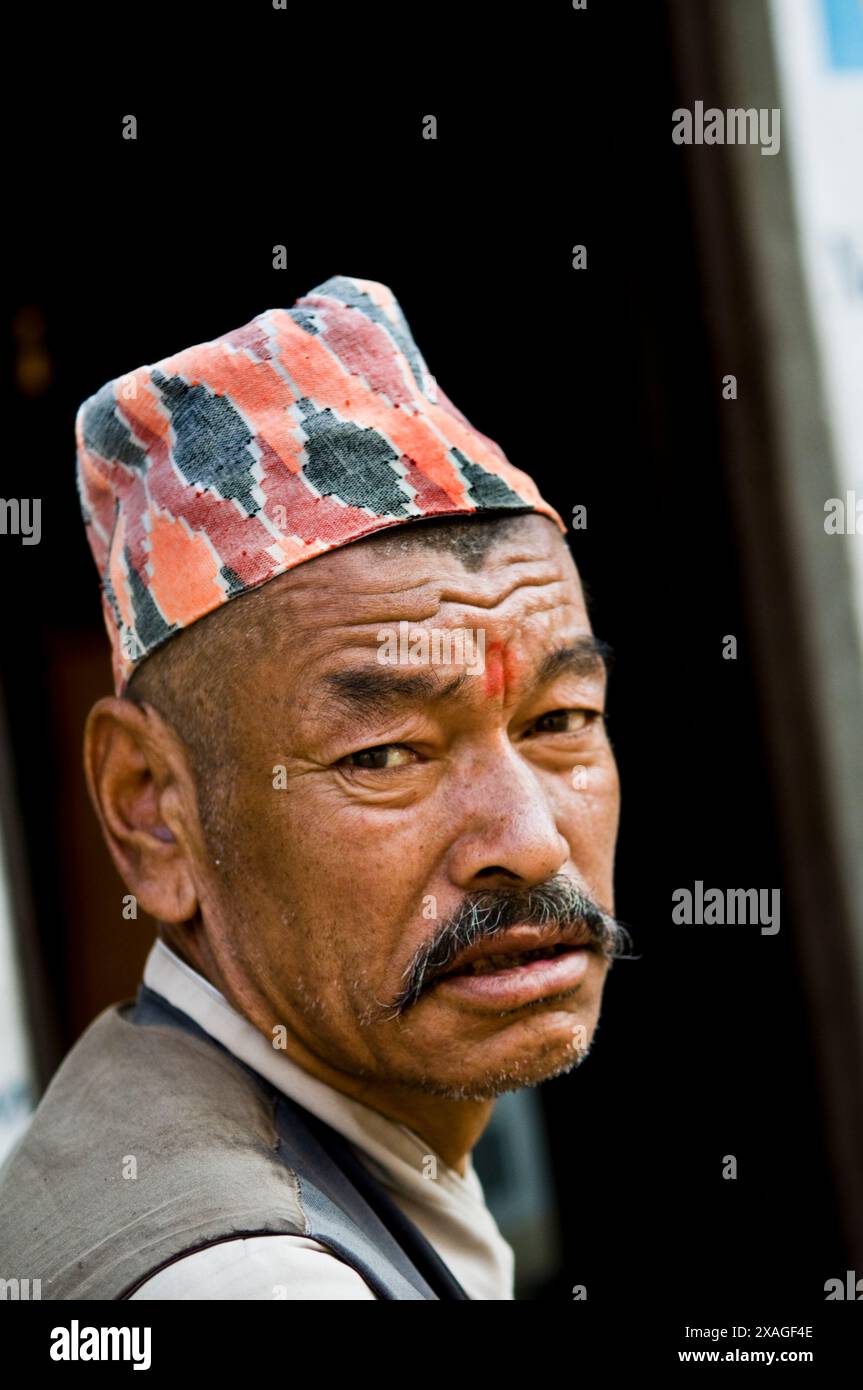 Portrait of a Nepali man wearing a traditional Dhaka Topi hat ...
