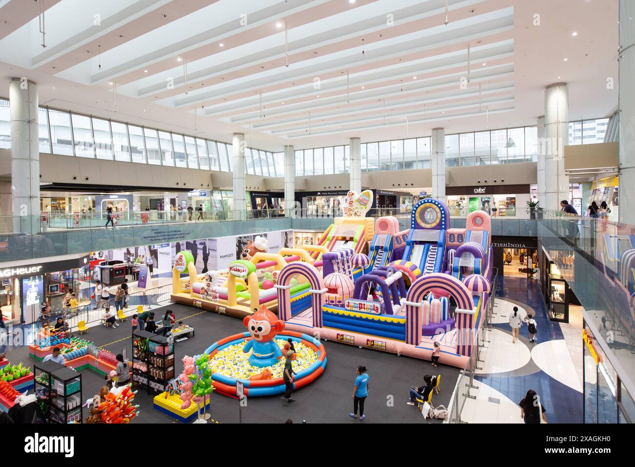 Inside a spacious shopping mall interior. A huge bouncy castle is set ...