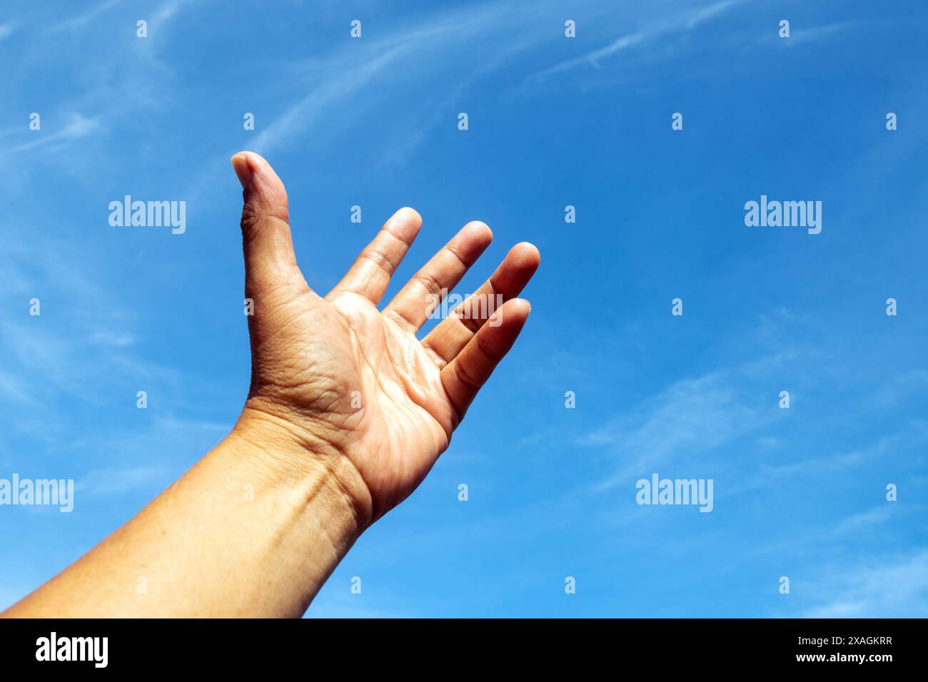 One left hand rise up to bright blue sky and white cloud likey need for ...