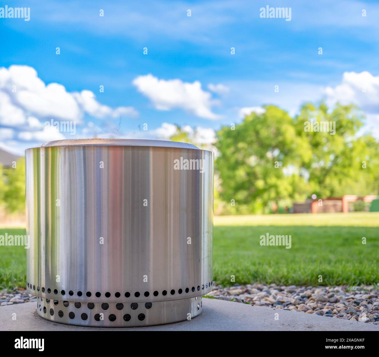 Smokeless stainless steel fire pit in a residential backyard in the ...