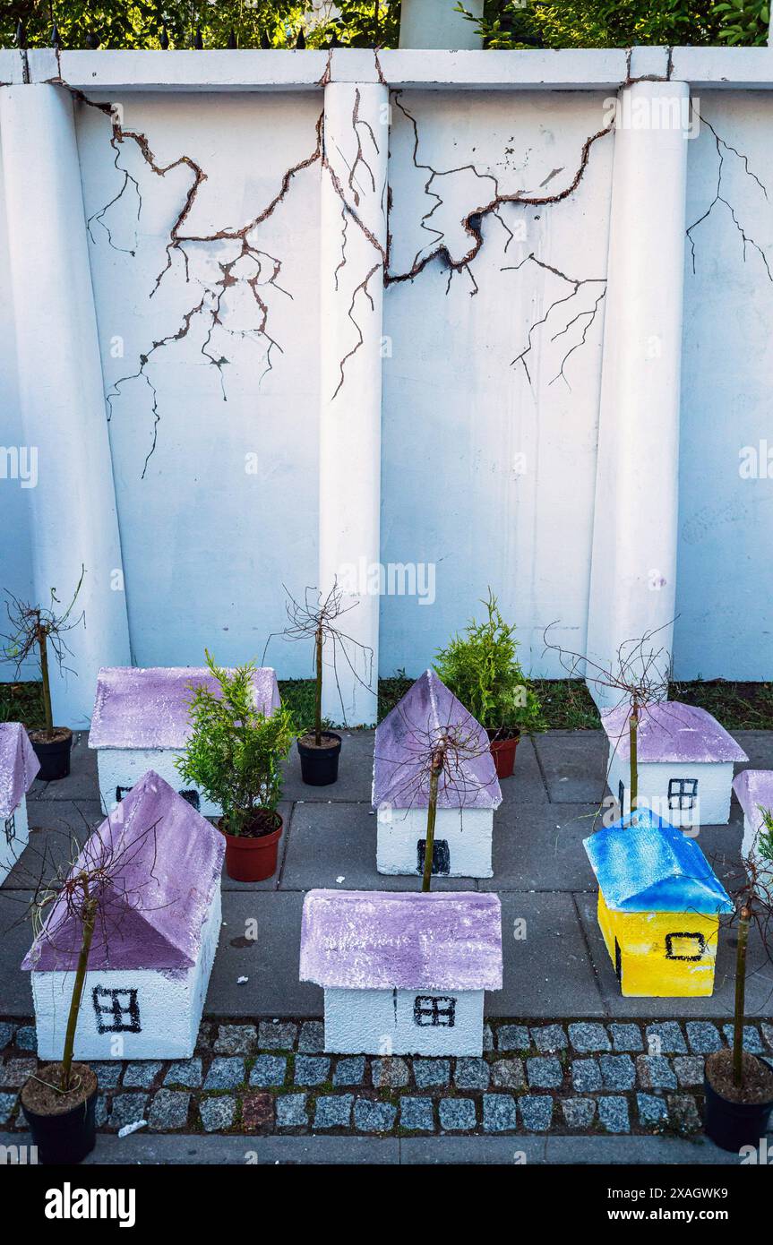 The model dam sits behind the miniature village during the rally. Pro ...