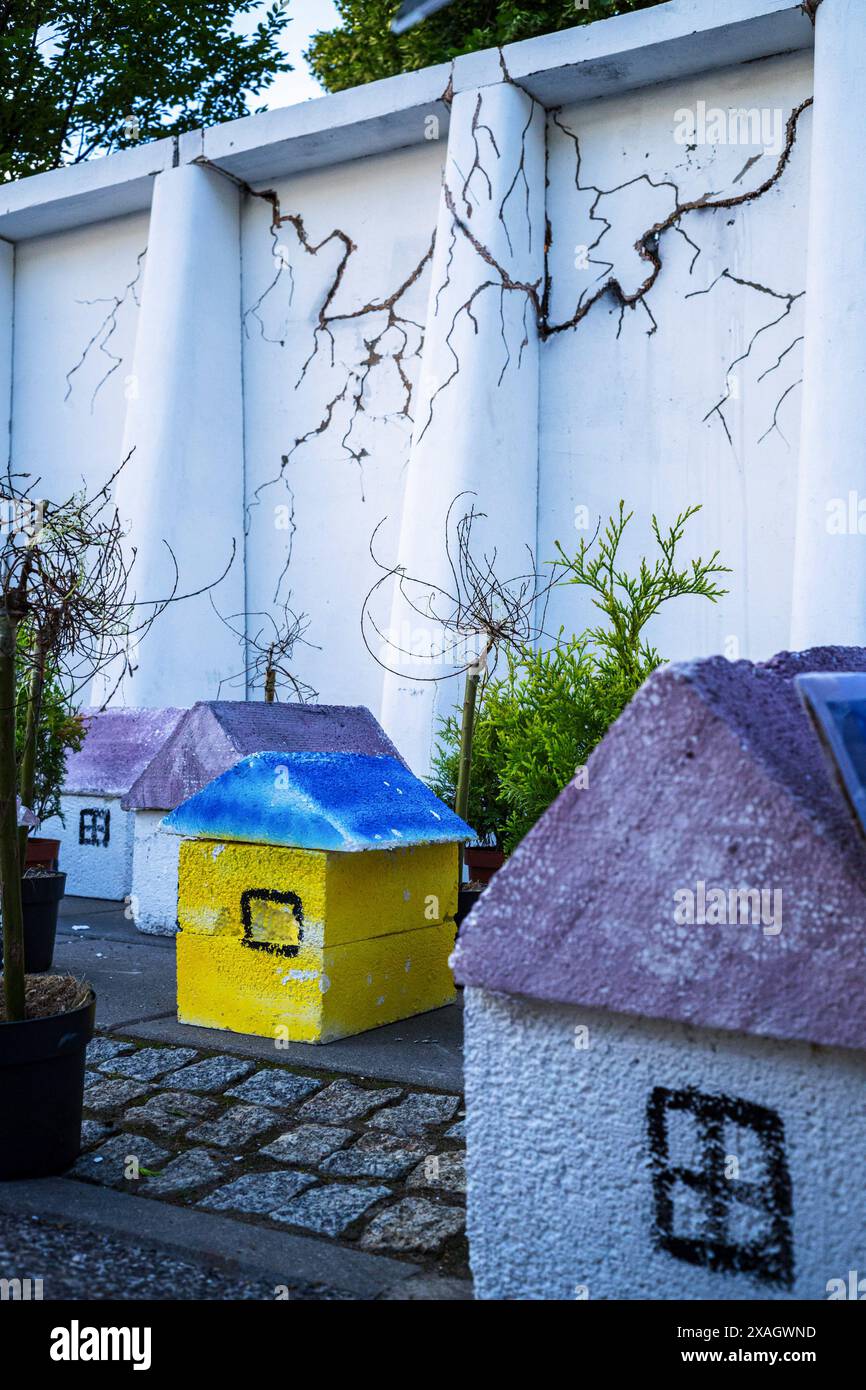 The model dam sits behind the miniature village during the rally. Pro ...