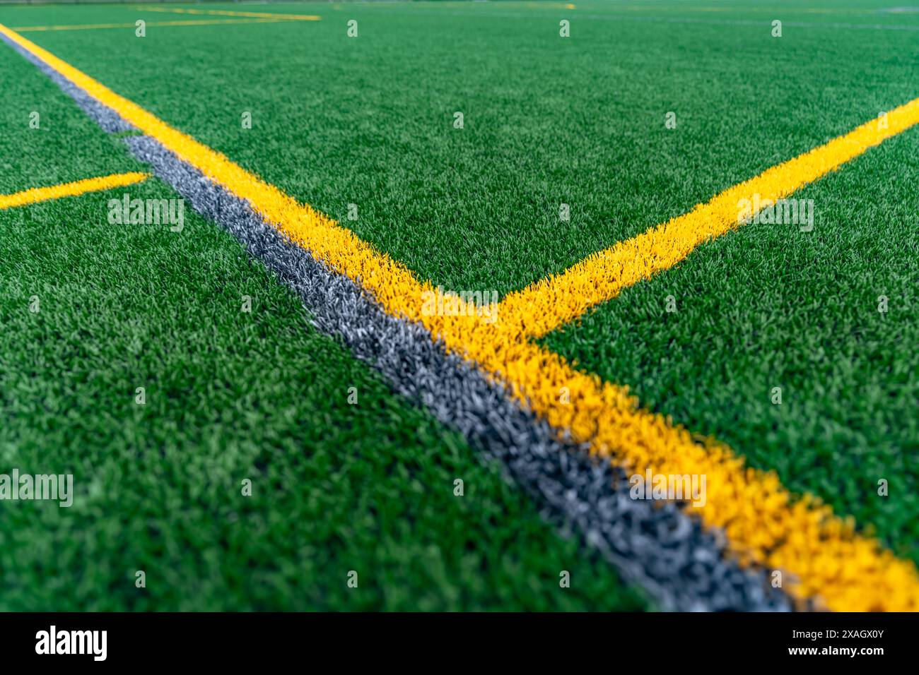 Late afternoon close up photo of gray football line with yellow soccer ...