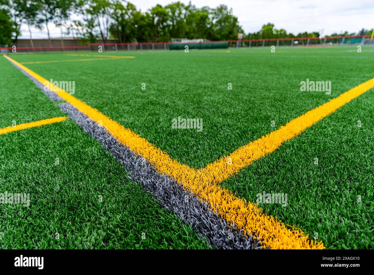 Late afternoon close up photo of gray football line with yellow soccer ...